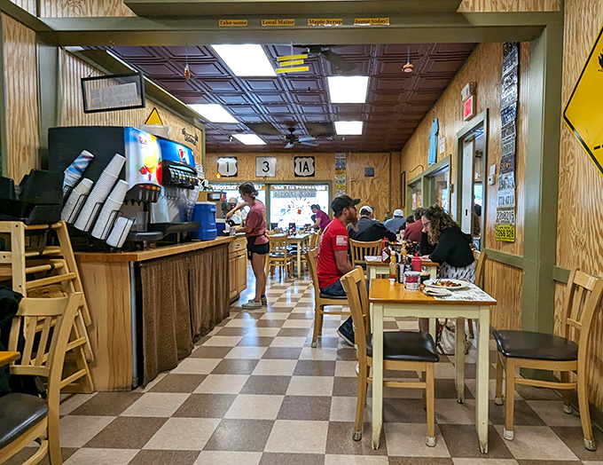 The counter service area hums with efficiency and warmth. The checkered floor leads your eye to where breakfast dreams come true, one plate at a time.