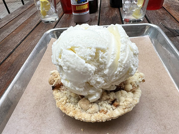 Ice cream melts languidly over warm cobbler like the final scene of a dessert romance movie, a sweet ending to a savory saga.