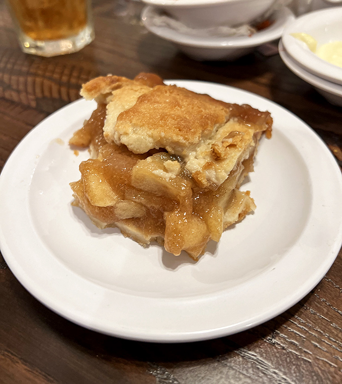 Apple pie so good it makes you question your grandmother's recipe. The glistening filling peeks through that perfectly flaky crust.