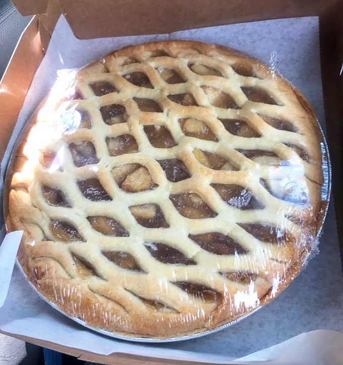 This lattice-topped apple pie isn't just dessert&mdash;it's edible architecture protecting a treasure of perfectly spiced apples beneath its golden crust.