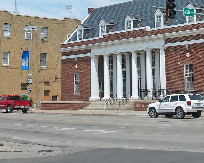 The stately building on Ash Street stands as an architectural anchor, its columns and symmetry reflecting small-town America's appreciation for classical design.