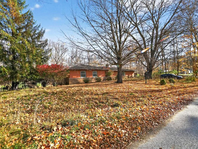 Fall foliage creates nature's confetti around this modest home. Logansport's residential streets become galleries of amber and crimson when October arrives.