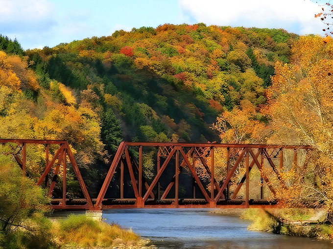 Fall foliage and rusty railroad trestles create the kind of scene that makes professional photographers question their filter choices.