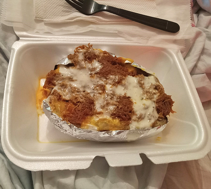 This loaded baked potato isn't just a side – it's a main event that happens to be wearing a foil jacket.