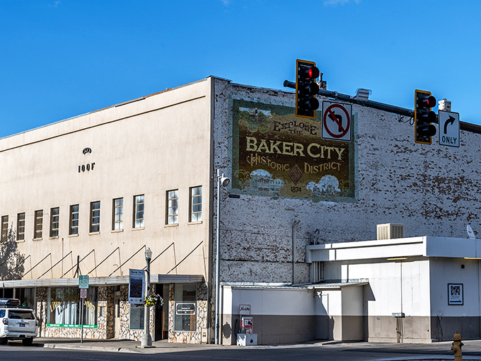 The fading "Baker City Historic District" mural tells stories in peeling paint, a reminder that authenticity sometimes comes with a weathered edge.