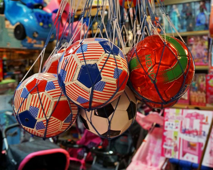 Soccer balls dangling like colorful fruit ready for harvest&mdash;pick one and you're instantly the neighborhood hero who brought the game.