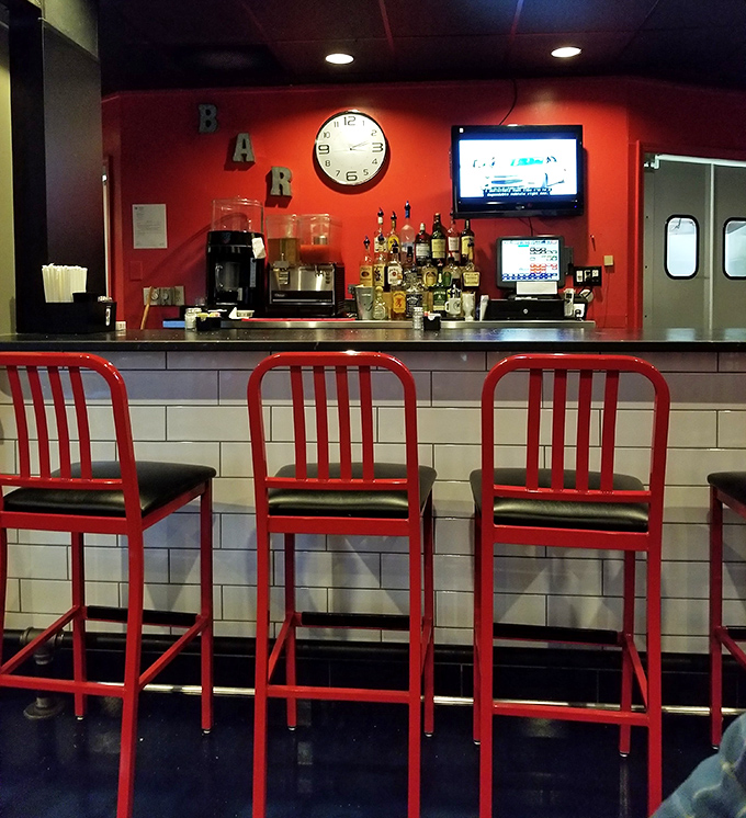 The bar area's vibrant red chairs invite you to pull up a seat and stay awhile. Those stools have heard all the best food confessions and deepest menu deliberations.