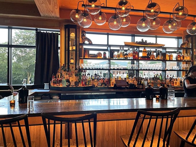 A backlit bar showcasing Vermont spirits glows like a beacon of craftsmanship and creativity for thirsty travelers.