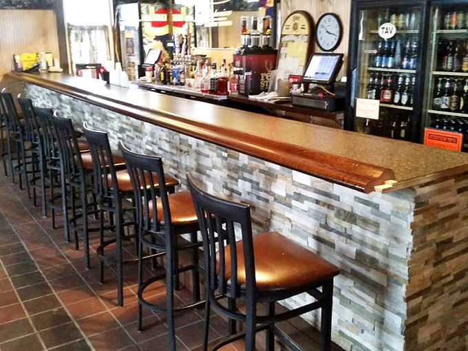 The bar where stories get better with each telling, where the wood's been polished by countless elbows, and where your empty glass never stays that way for long.