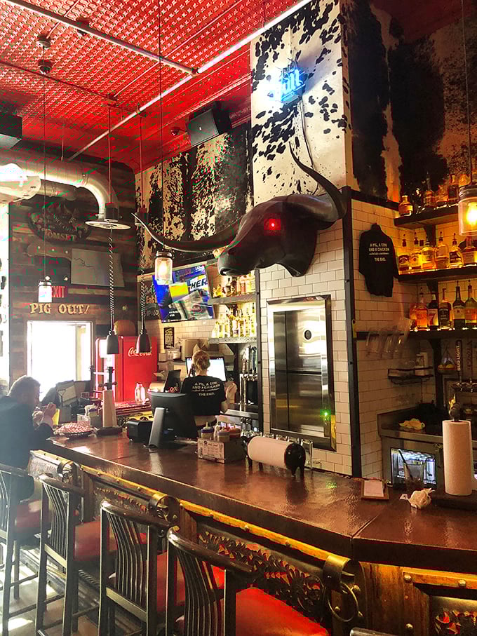 The bar area, crowned by that magnificent bull head, serves as command central for bourbon-based happiness and barbecue-appropriate libations.