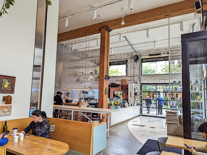 High ceilings and exposed infrastructure create a cathedral-like space where pizza is both the art and the sacrament.