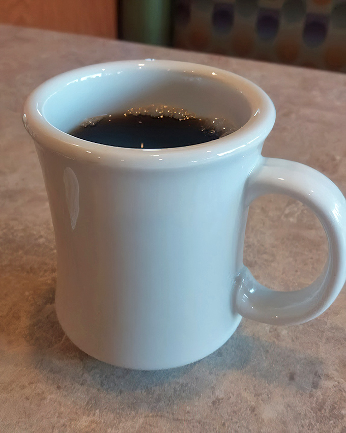 The humble diner coffee mug—unassuming, sturdy, and filled with the life-giving elixir that makes morning conversations possible. A true American hero.