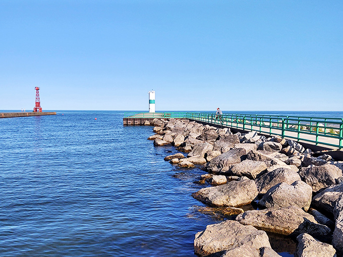 The channel's pier stretches toward Lake Michigan like a runway for dreams, guiding boats safely between two worlds of water.
