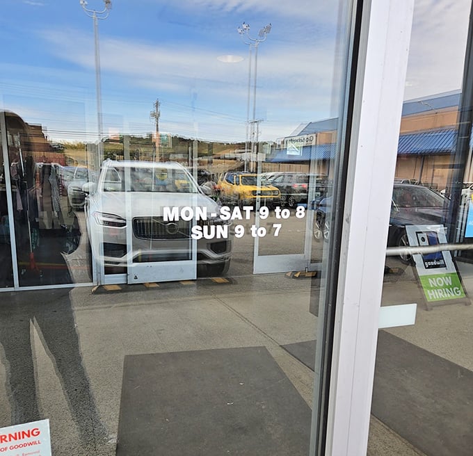 Extended hours mean more chances to hunt for treasures. The "Now Hiring" sign hints at the constant flow of donations needing sorting.