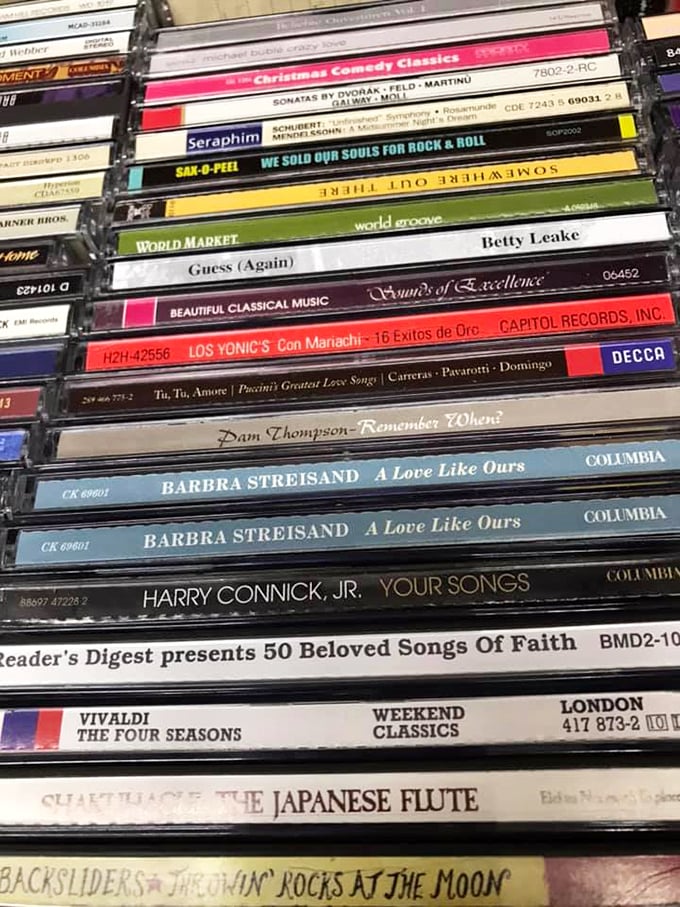 CD stacks that read like a time capsule of American music taste. Two Barbra Streisand albums side-by-side? Someone's serious about their collection.