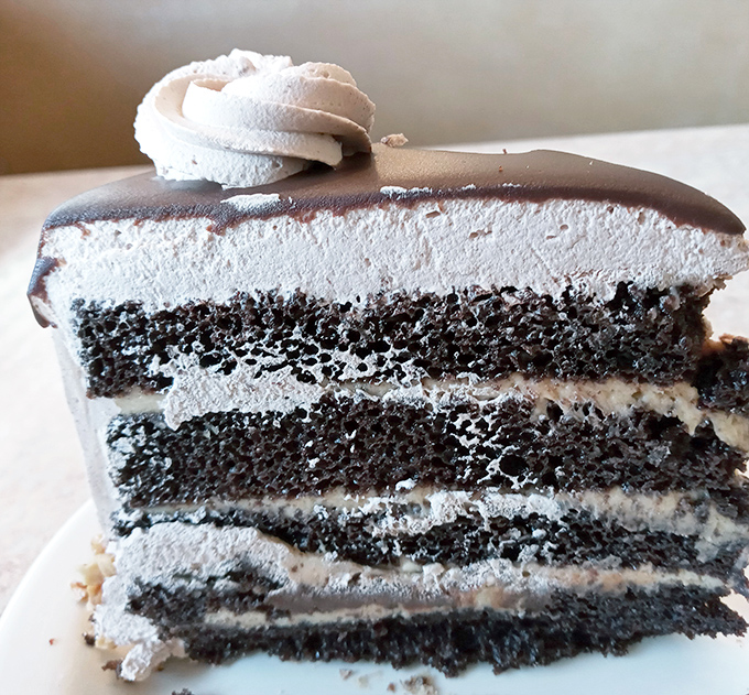 Layer upon layer of chocolate cake and cream – architectural perfection that makes skyscrapers seem simple by comparison.