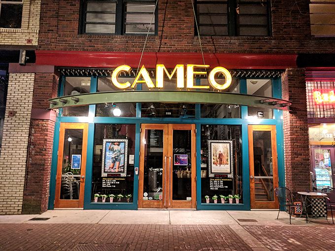 The Cameo Art House Theatre's vintage marquee glows with nostalgic charm, offering cinematic experiences beyond the predictable multiplex fare.