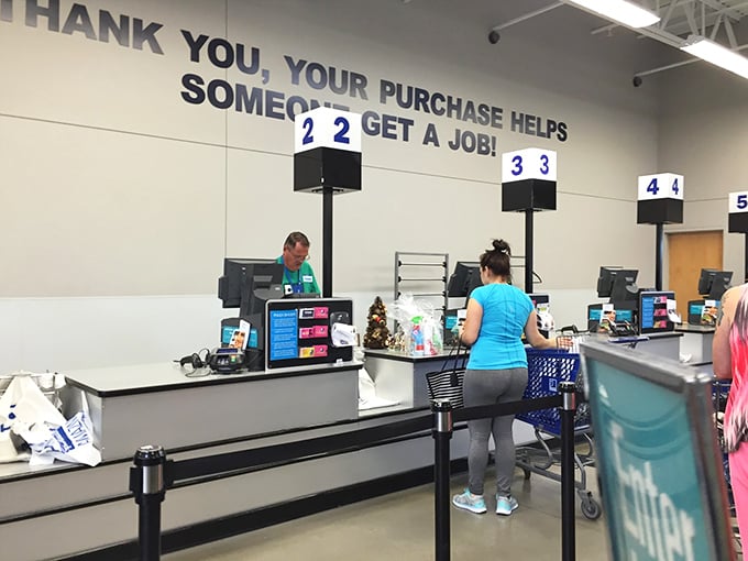 "Your purchase helps someone get a job!" The checkout area reminds shoppers of Goodwill's mission while friendly staff process the day's discoveries.