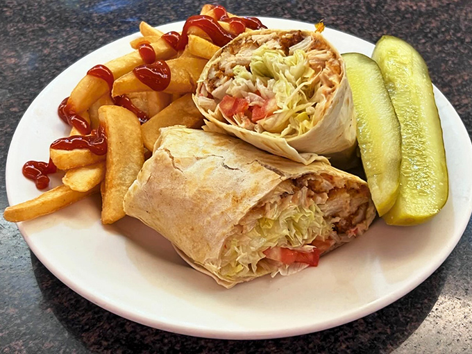 This chicken wrap isn't just lunch&mdash;it's edible architecture. Perfectly rolled with crisp vegetables and golden fries standing by for dipping duty.