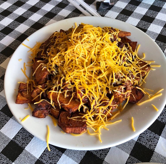 Potatoes transformed into a mountain of comfort, crowned with melted cheese that stretches with each forkful&mdash;proof that sometimes more is exactly right.