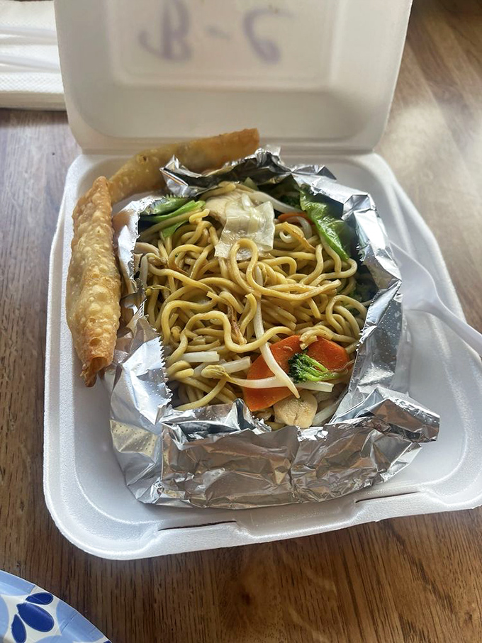 To-go perfection that travels well but rarely makes it home intact. That egg roll is the perfect sidekick to those savory noodles.