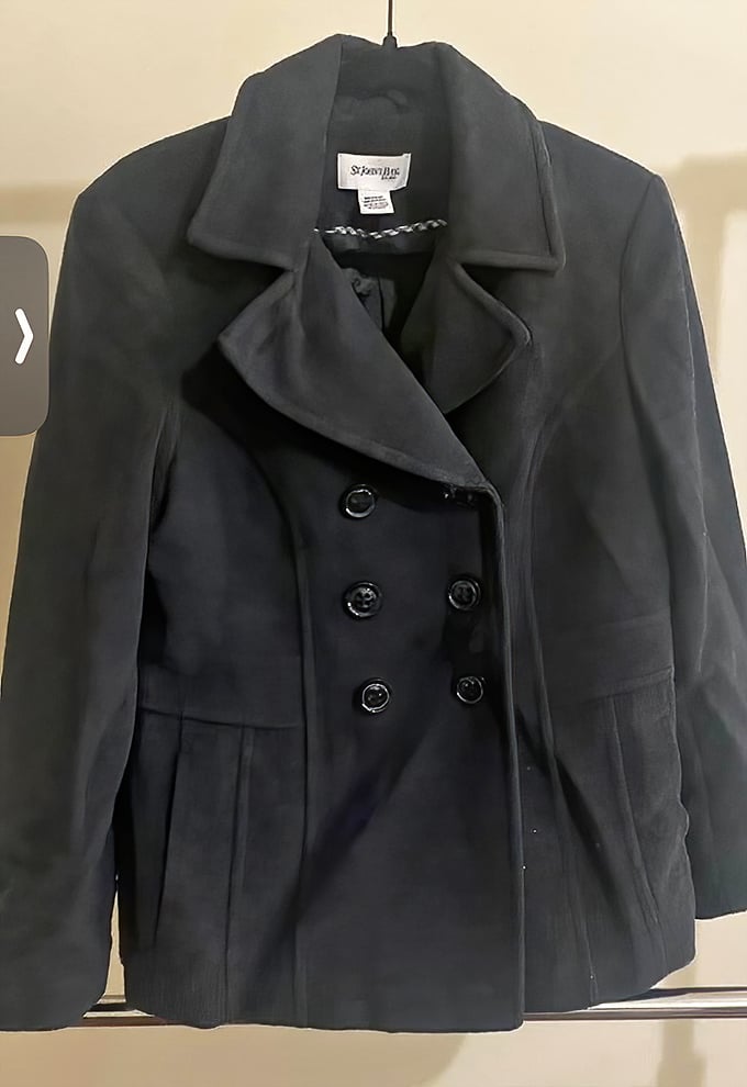 A classic peacoat hanging patiently, waiting for cooler weather and its next adventure. Timeless style that's survived at least one winter already.