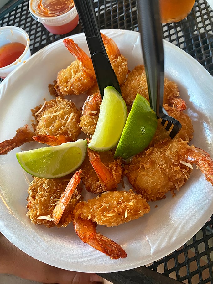 Coconut shrimp that deliver the perfect crunch-to-juicy ratio. Those lime wedges aren't just garnish &ndash; they're the key that unlocks the full flavor experience.