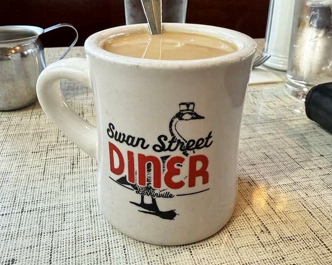 Coffee served in a mug that means business. The Swan Street logo isn't just branding&mdash;it's a promise that what's inside will transform you from zombie to human.