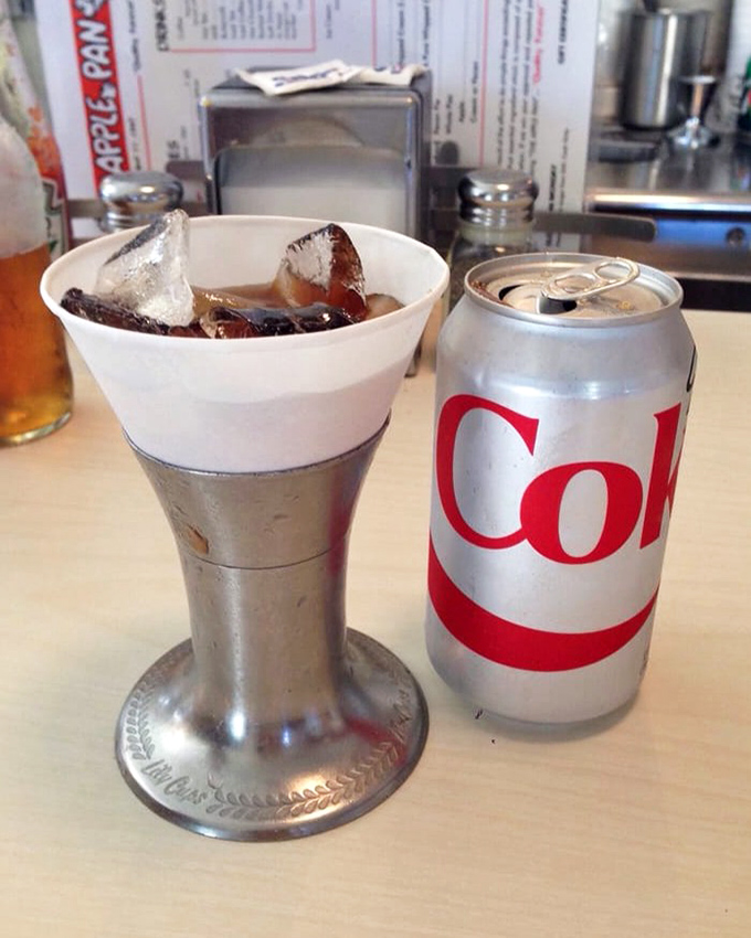 Even Coca-Cola tastes better here, served in that timeless paper cone that turns refreshment into nostalgia.