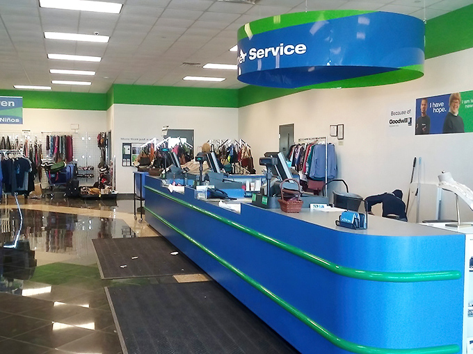 The customer service counter stands ready, its blue and green hues a beacon for shoppers navigating this sea of secondhand treasures.
