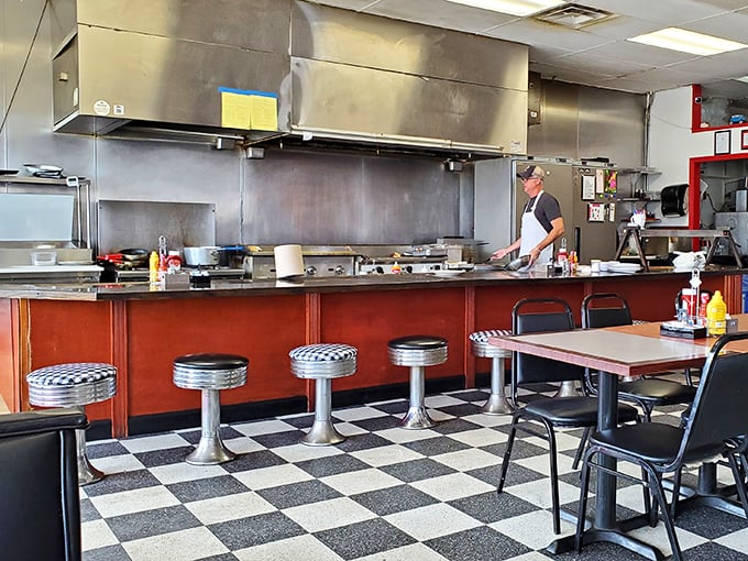 Chrome stools at a counter where strangers become friends over coffee refills. This is America's original social network, no Wi-Fi required.