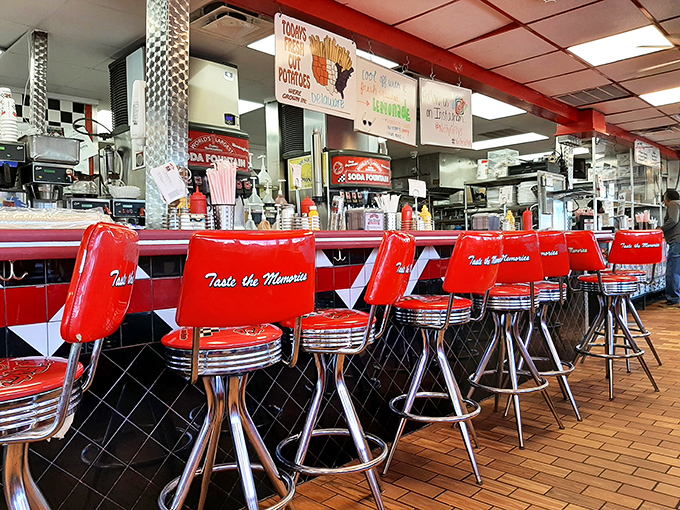 Red vinyl stools emblazoned with "Taste the Memories" aren't just seating—they're front-row tickets to the greatest show on earth: American diner food done right.