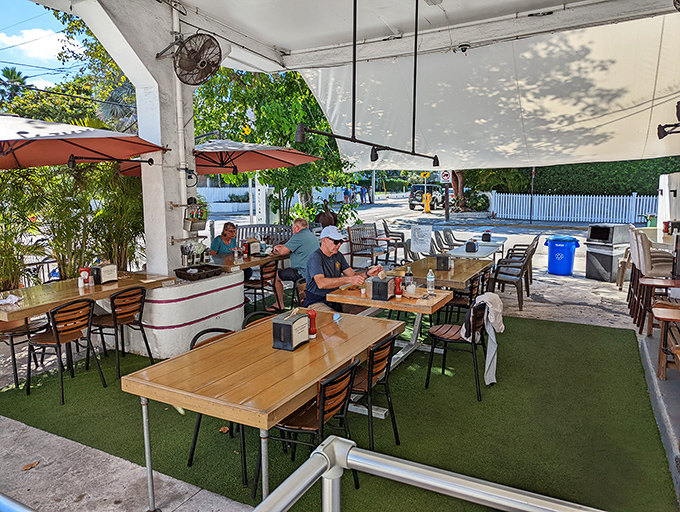 Diners enjoying the simple pleasure of exceptional seafood under the shade. No white tablecloths needed when the food is this good.