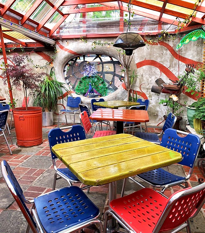 The garden patio feels like stumbling into a secret urban oasis, where colorful furniture and whimsical design create the perfect backdrop for alfresco dining.
