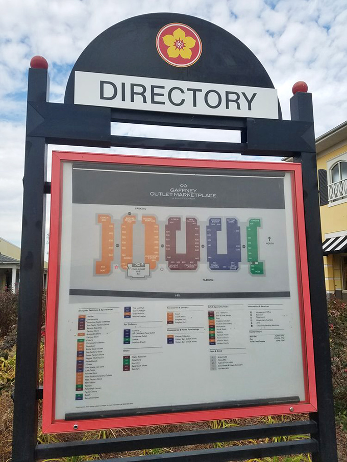 The directory sign stands like a treasure map, X marking the spots where your wallet can breathe easier while your closet gets happier.