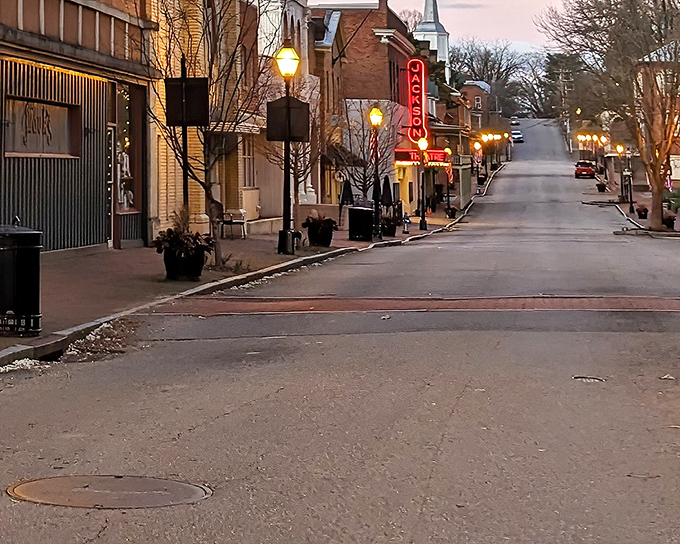 Twilight transforms Main Street into a golden-hued movie set. The vintage theater sign glows like a beacon, drawing visitors into Jonesborough's evening charm.
