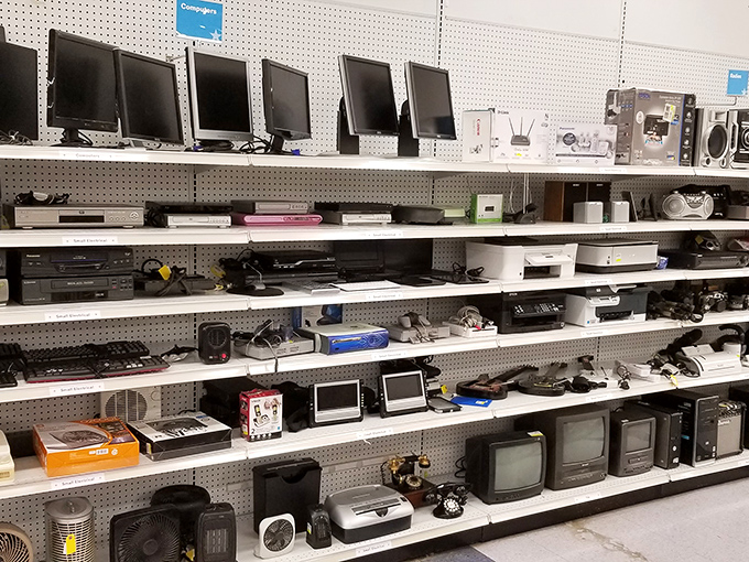 Technology's timeline displayed on pegboard &ndash; from bulky CRTs to slim monitors, each device a chapter in our digital evolution.