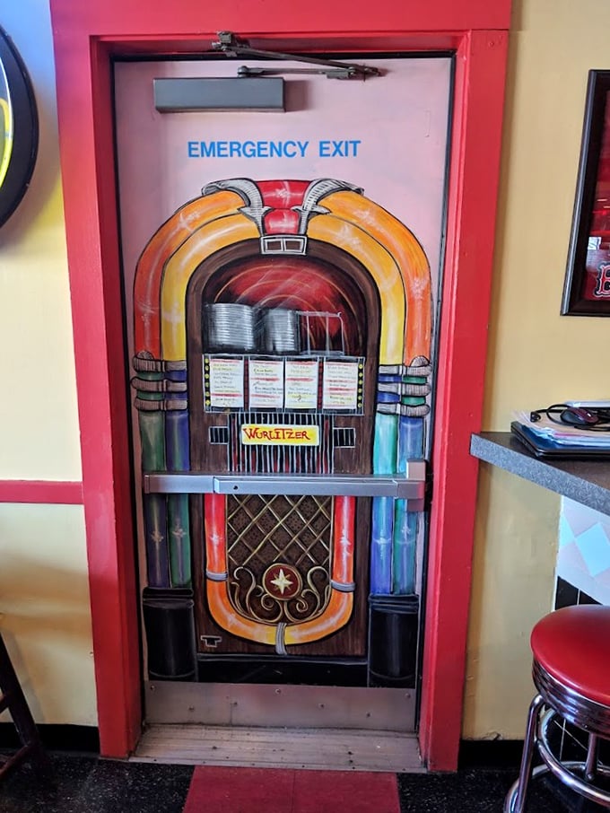 Even the emergency exit is on theme! This painted jukebox door proves that at Tilt'n Diner, every detail is served with a side of nostalgia.