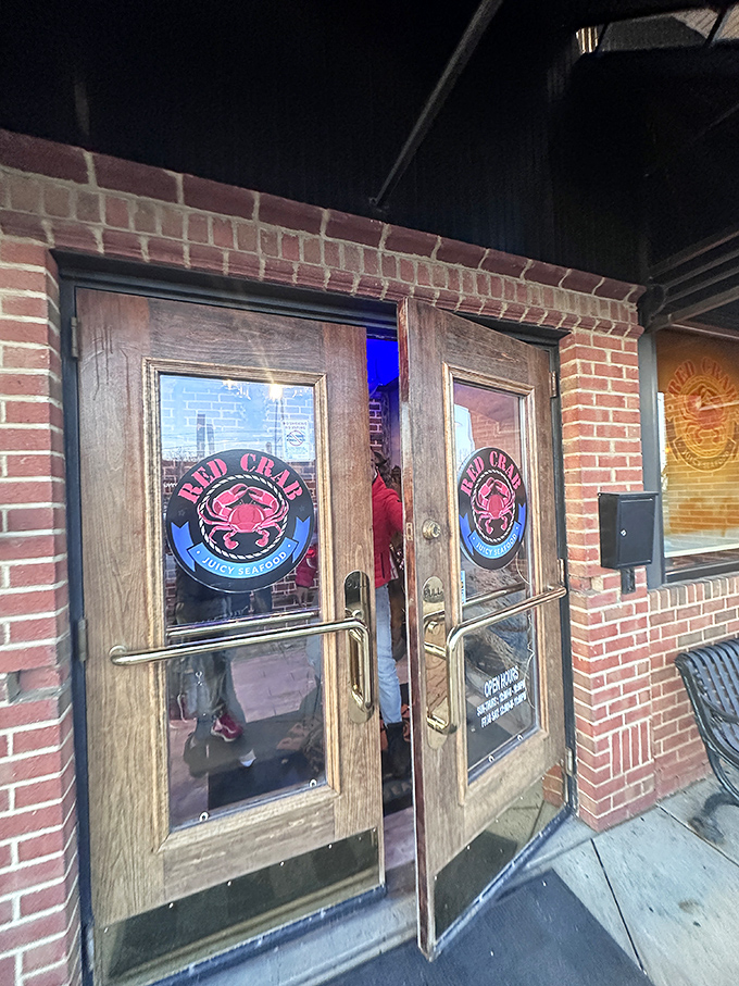 Wooden doors with the Red Crab logo serve as the gateway to flavor town &ndash; a portal between the ordinary world and a realm of buttery, spicy seafood delights.