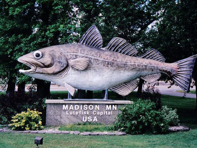 The statue's facade shows remarkable weathering, a testament to surviving countless Minnesota winters with stoic fish dignity.