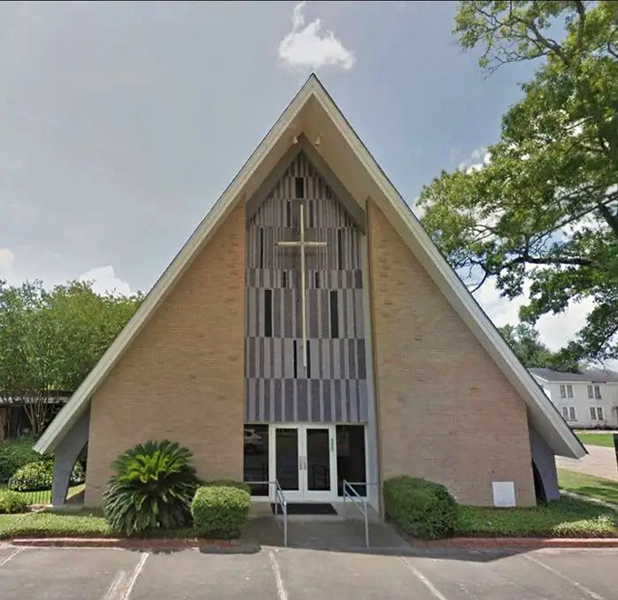 The A-frame church with its striking cross window creates a distinctive silhouette against Oakdale's big Louisiana sky.