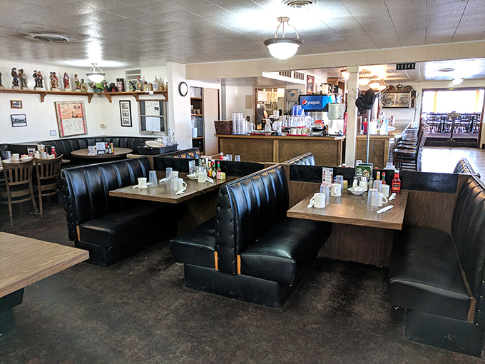 Classic diner booths where breakfast decisions are contemplated with the seriousness they deserve. The coffee is probably flowing as freely as the local gossip.
