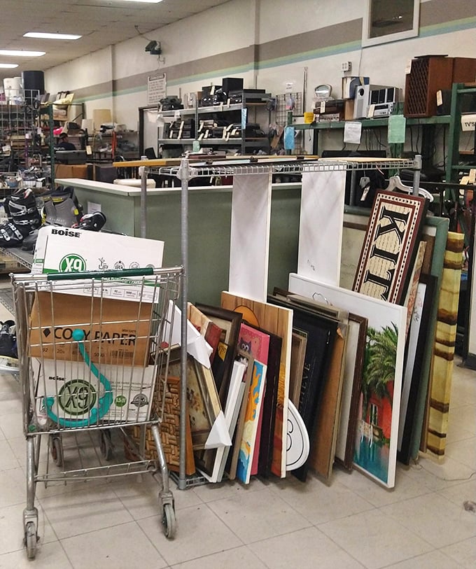 Framed artwork leans casually against a shopping cart, waiting for the perfect wall. Someone's "what was I thinking?" becomes another's "this is exactly what I needed!"