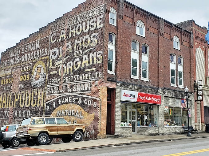 Ghost signs from bygone businesses haunt this historic building, now home to Frey's Auto Supply—where Grafton's past and present coexist in budget-friendly harmony.