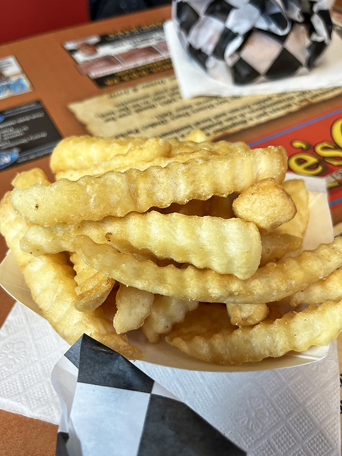 Waffle fries stacked high and golden, ready to disappear faster than your willpower around a basket of carbs.