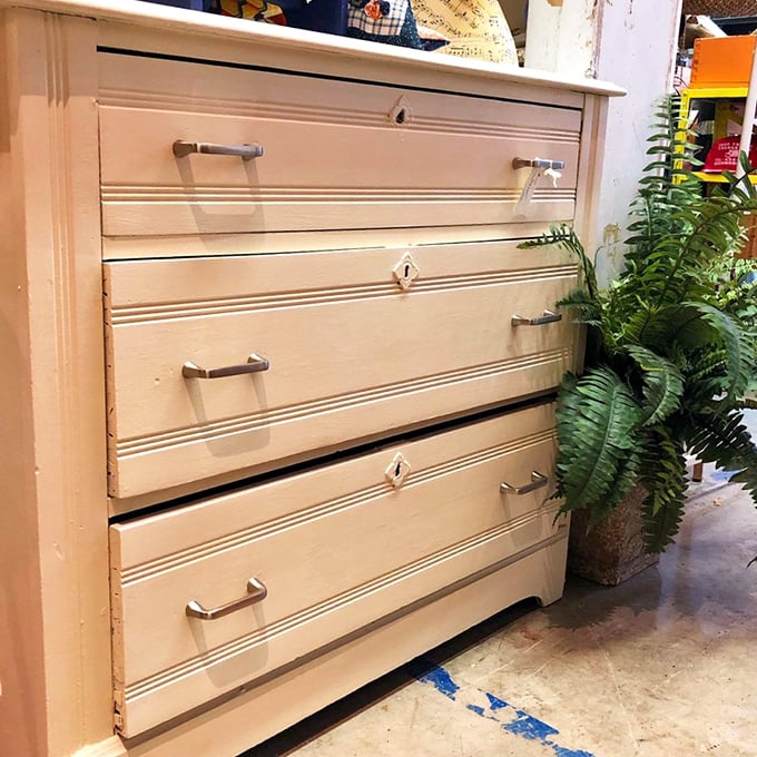 This cream-colored dresser has survived longer than most marriages. Solid wood construction with personality lines that IKEA can only dream about.