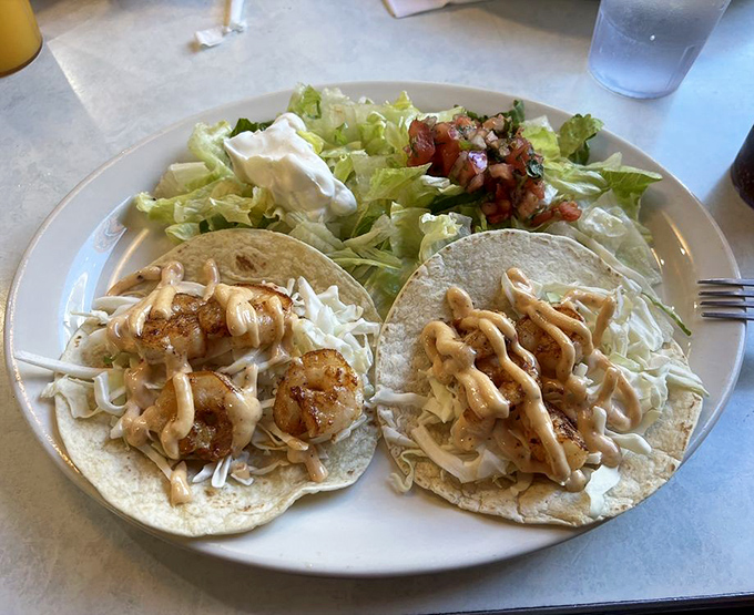 These shrimp tacos deliver a coastal vacation on a plate&mdash;plump crustaceans nestled on beds of crisp slaw with sauce drizzled like abstract art.