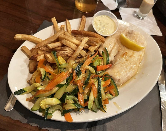 A perfectly cooked fish fillet sharing the spotlight with vibrant vegetables and golden fries&mdash;proof that diner seafood can be a revelation.
