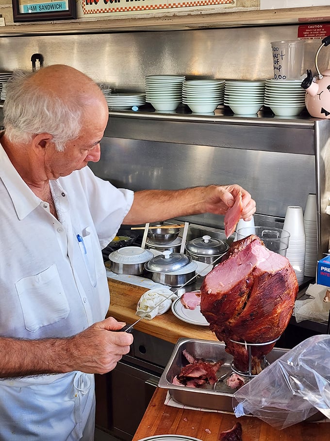 The ham master at work, slicing with the precision of a surgeon and the reverence of an artist. This is craftsmanship you can taste.