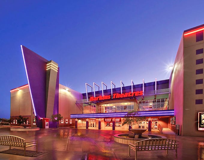 Harkins Theatre's neon glow against the twilight sky promises air-conditioned escape from reality. Desert movie magic at its finest.